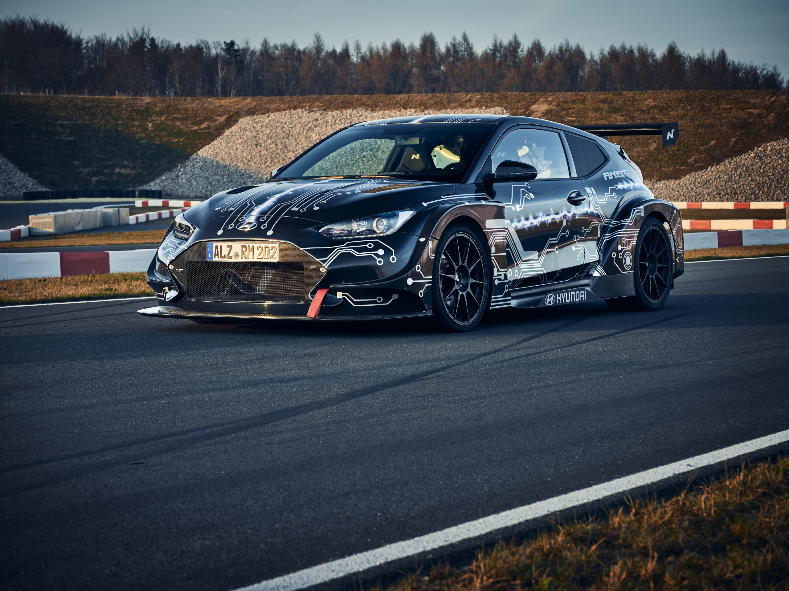 Watch a mid-engined Hyundai hatch tear up the track with Rimac e-power ...